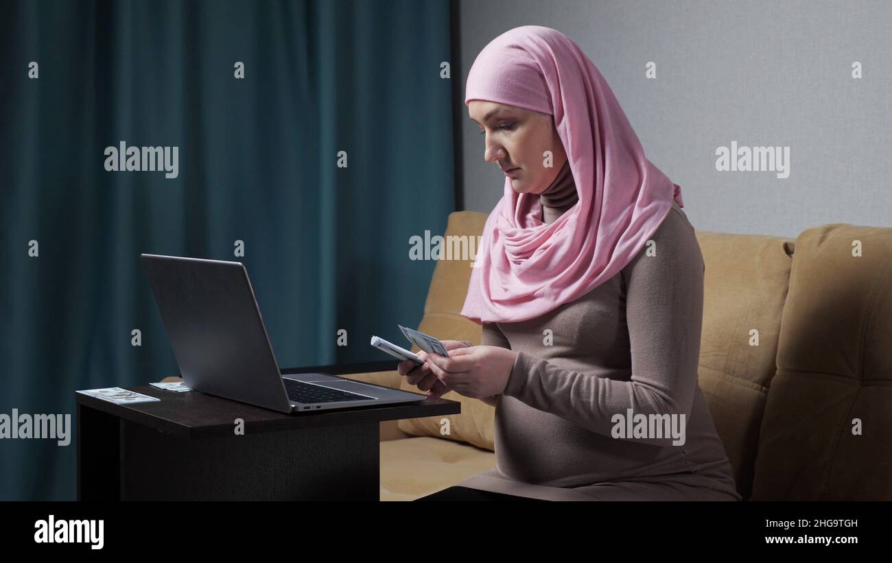 Pregnant Muslim divides income preparing for childbirth Stock Photo - Alamy