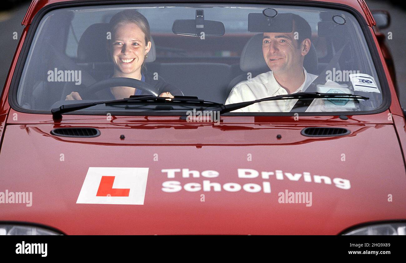 Woman taking a driving lesson with driving school instructor Stock ...