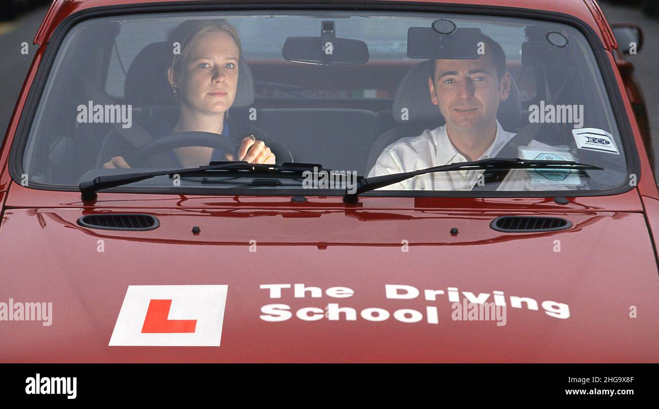 Woman taking a driving lesson with driving school instructor Stock ...