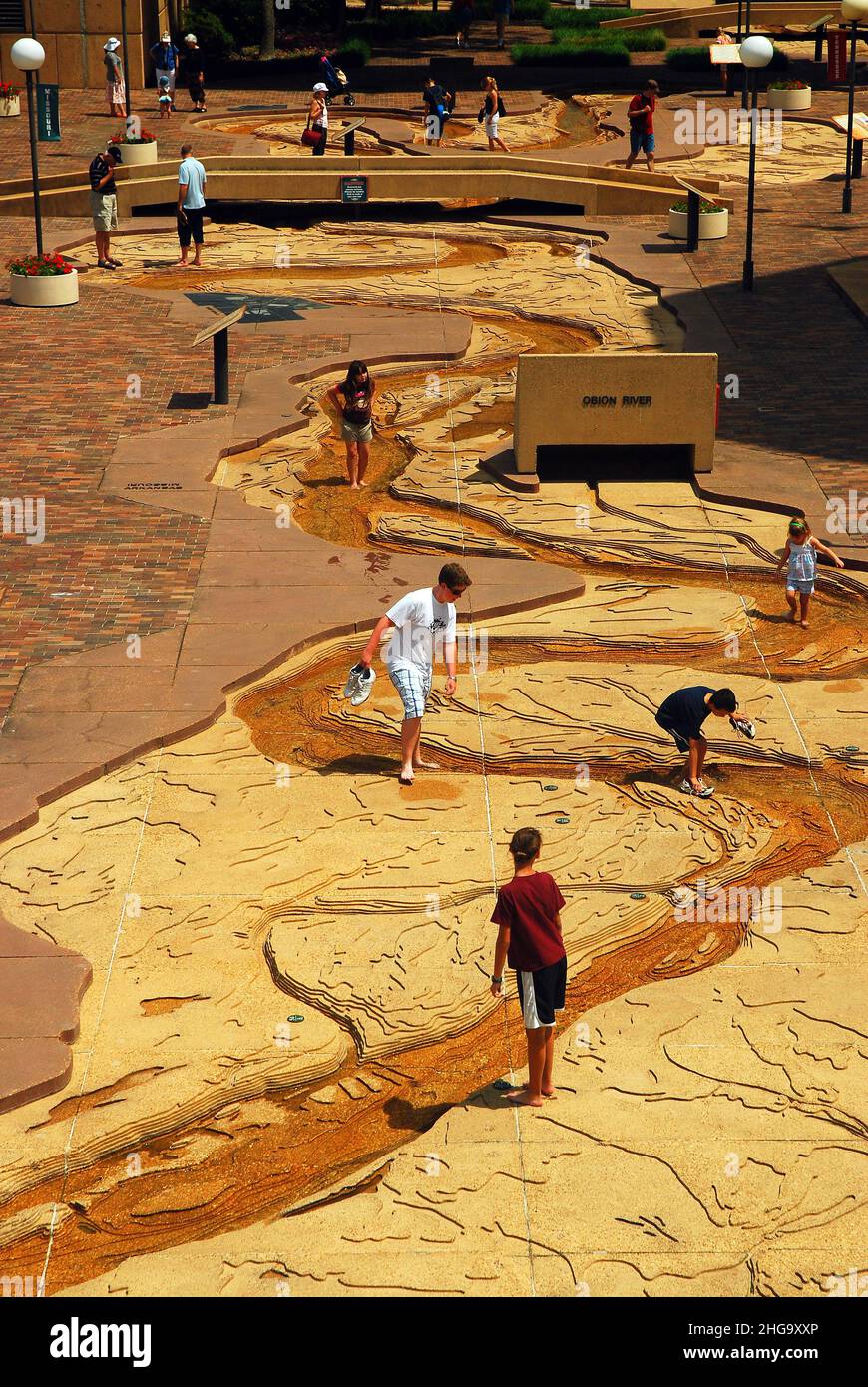 Visitors wade through a scale model of the Mississippi River on Mud ...