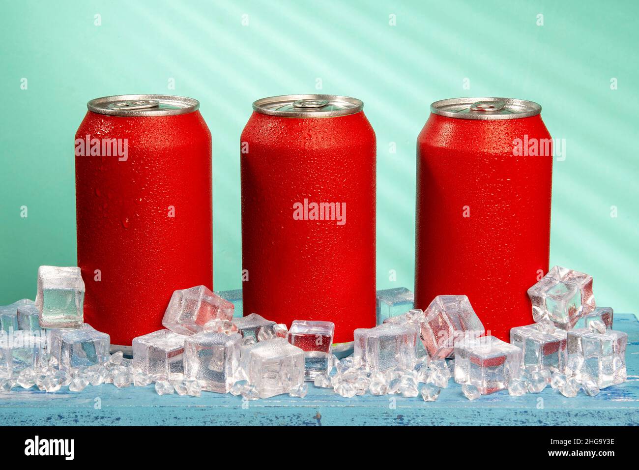 red soda can on blue background and with ice and cold Stock Photo - Alamy