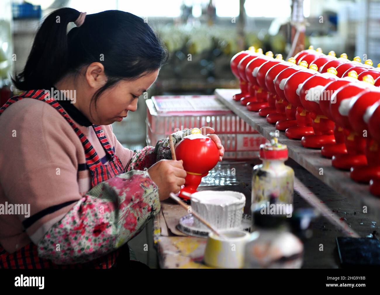Dehua, China's Fujian Province. 19th Jan, 2022. A worker colors a ...