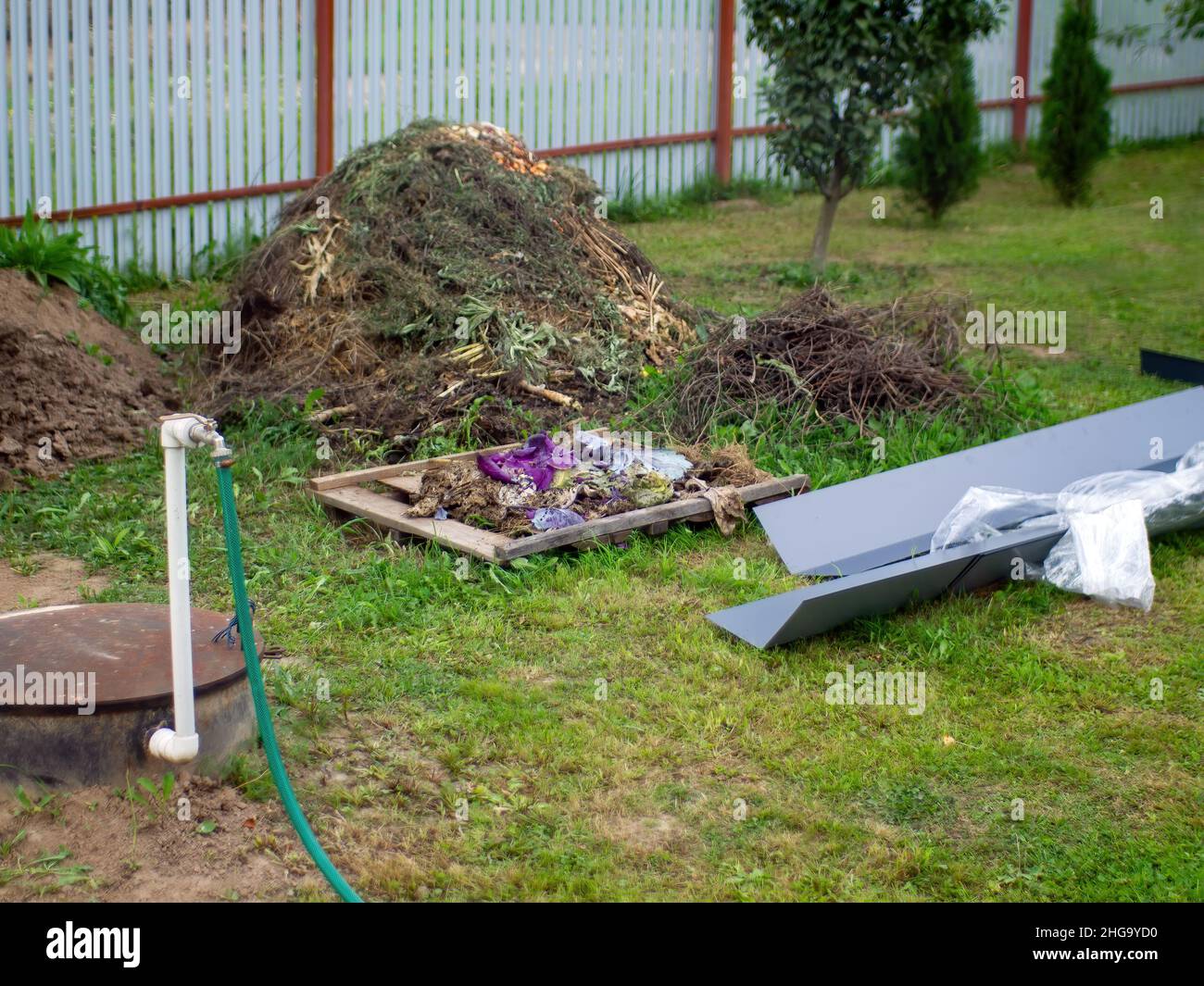 a pile of garbage from old plants in the garden, in summer Stock Photo ...