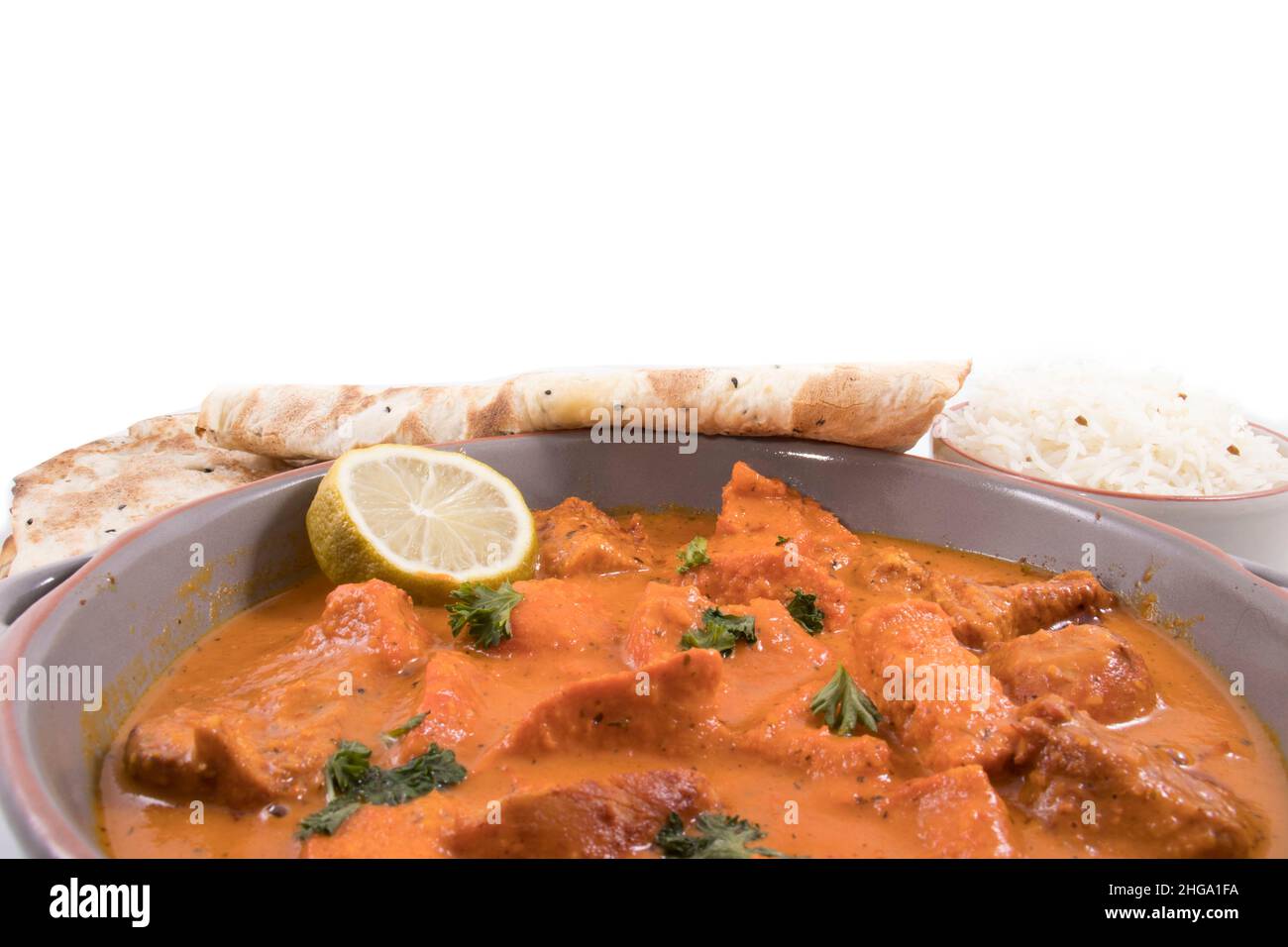butter chicken isolated on a white background Stock Photo - Alamy