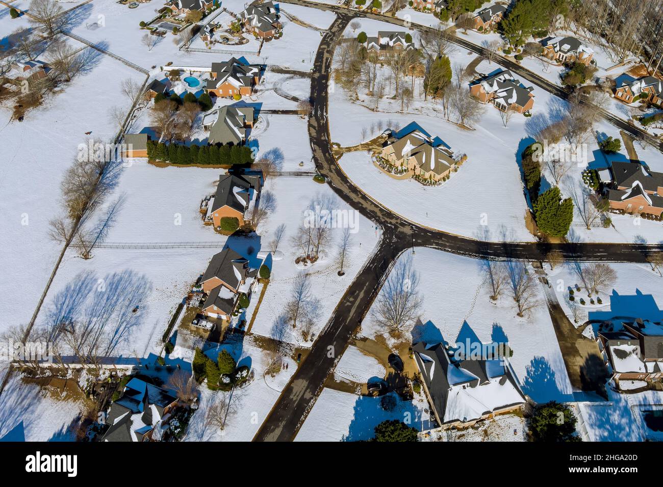 Aerial view a snowy winter day with house roofs covered by white snow ...