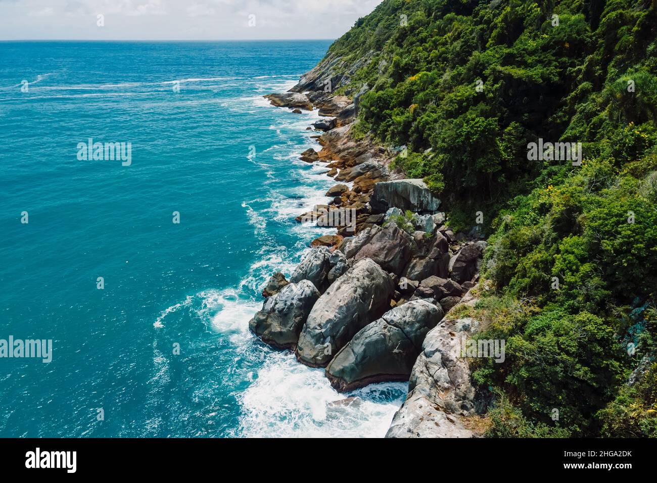 Scenic coastline with rocks, trees and blue ocean with waves in Brazil ...