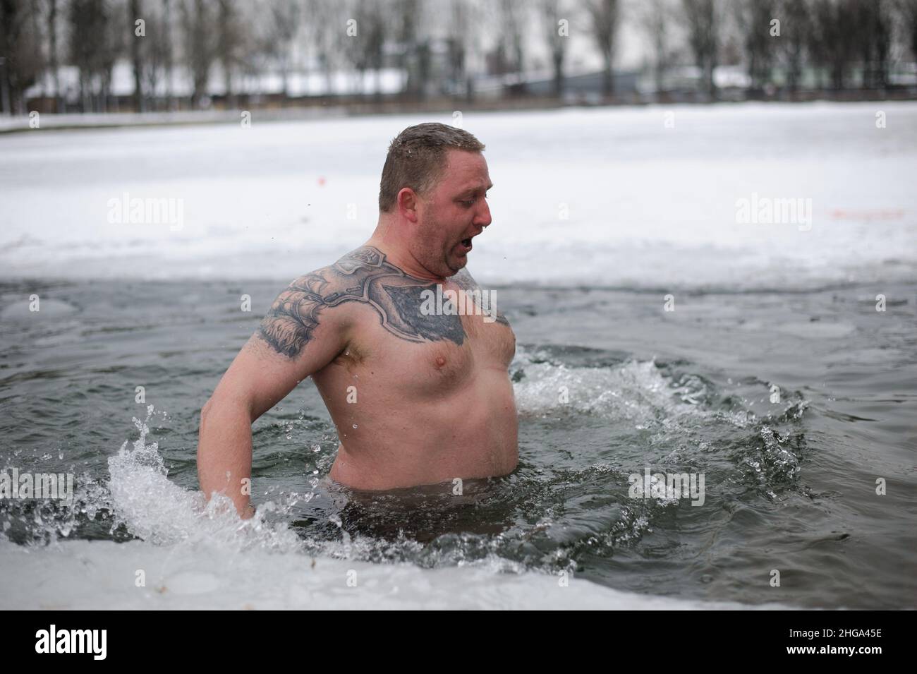 Lviv, Ukraine - 19 Jan 2022, A man takes a bath in cold water during ...