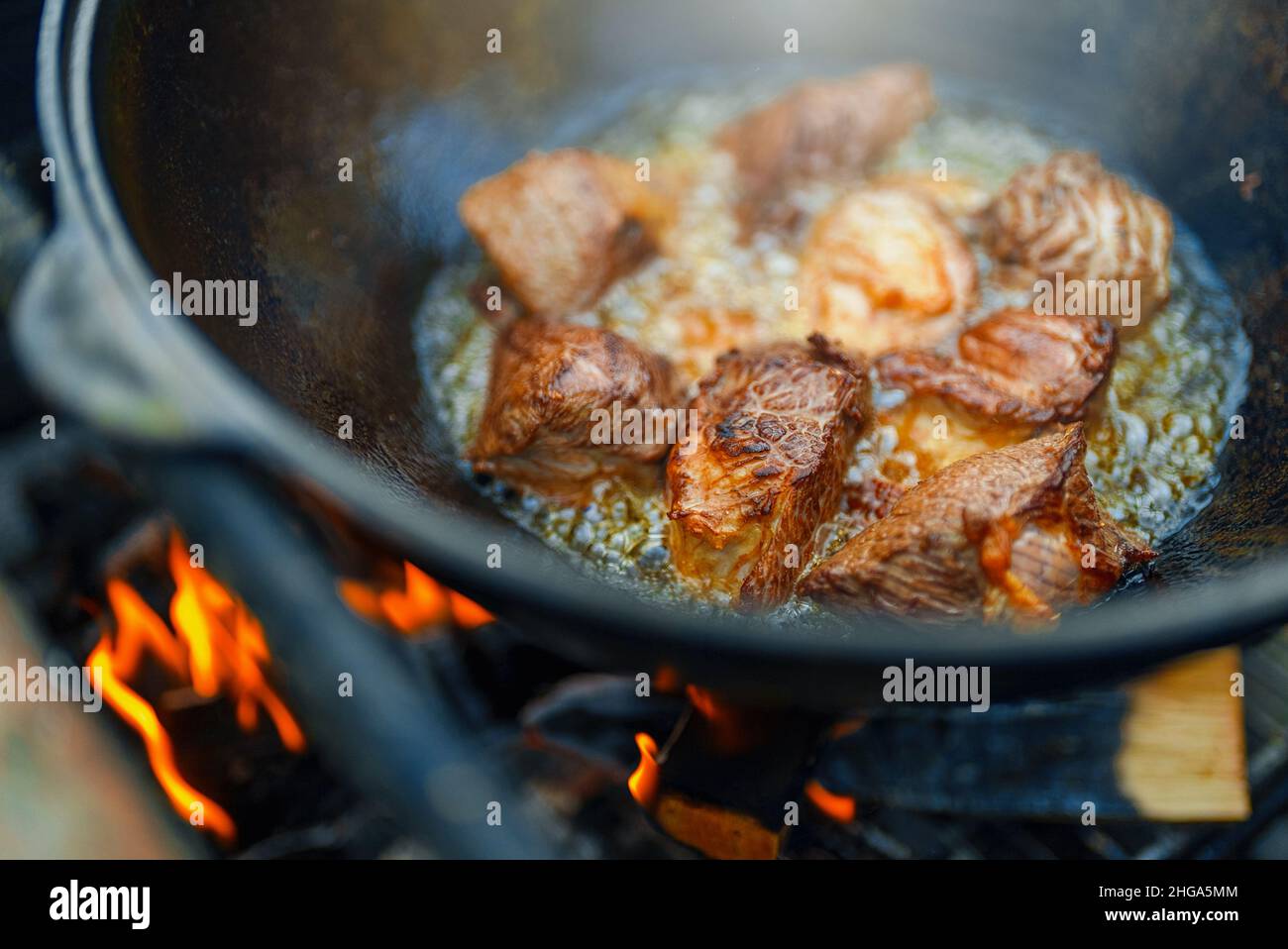 Meat is cooked in cauldron on fire. Step by step cooking of Pilaf Stock ...