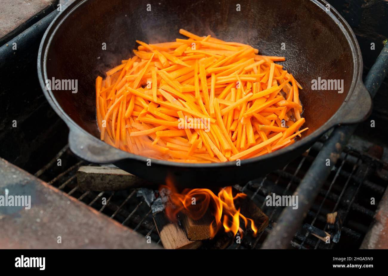Carrot is cooked in cauldron on fire. Step by step cooking of Pilaf ...