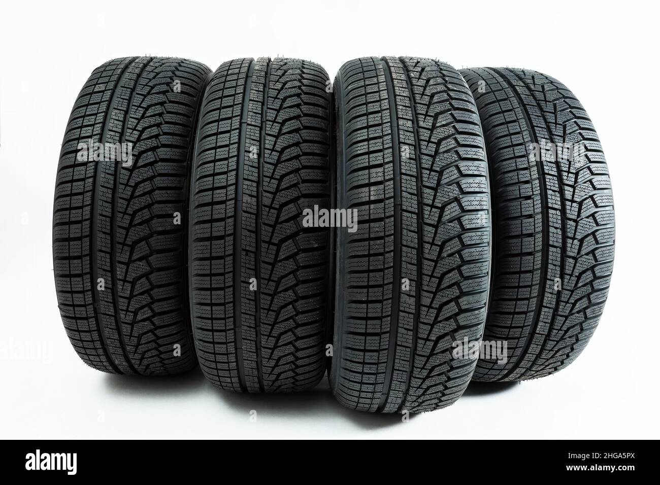 Winter tires rolling forward isolated on white background. Set of four ...