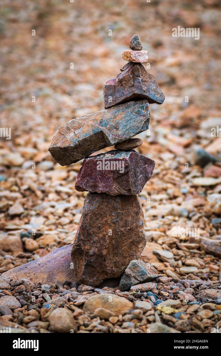 A rock cairn on a path of gravels at a hiking trail in the Spur Cross ...