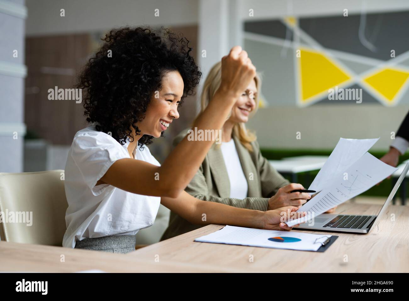 Beautiful adult businesswomen with elegant dress sitting at computer ...