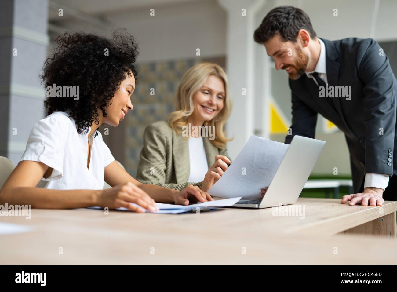 Multiracial group of businesspeople with elegant dress sitting at ...