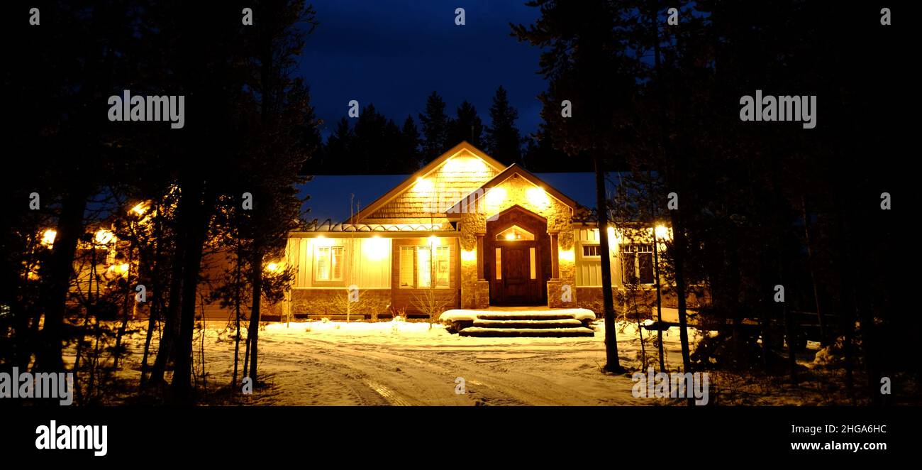Cabin in the woods wilderness at night time glowing warm lights Stock ...