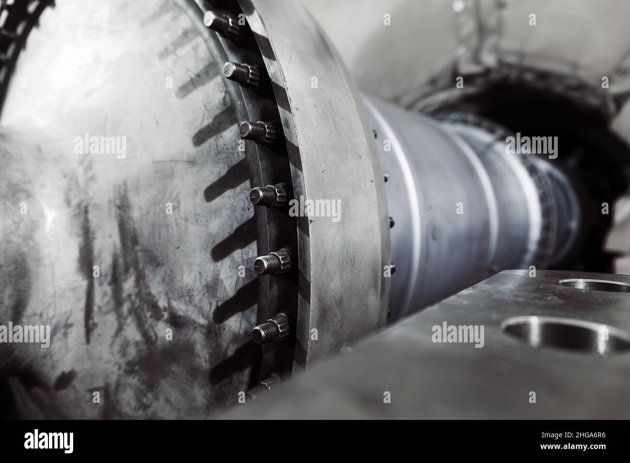 A gas turbine with a compressor rotor and a bolted coupling half ...