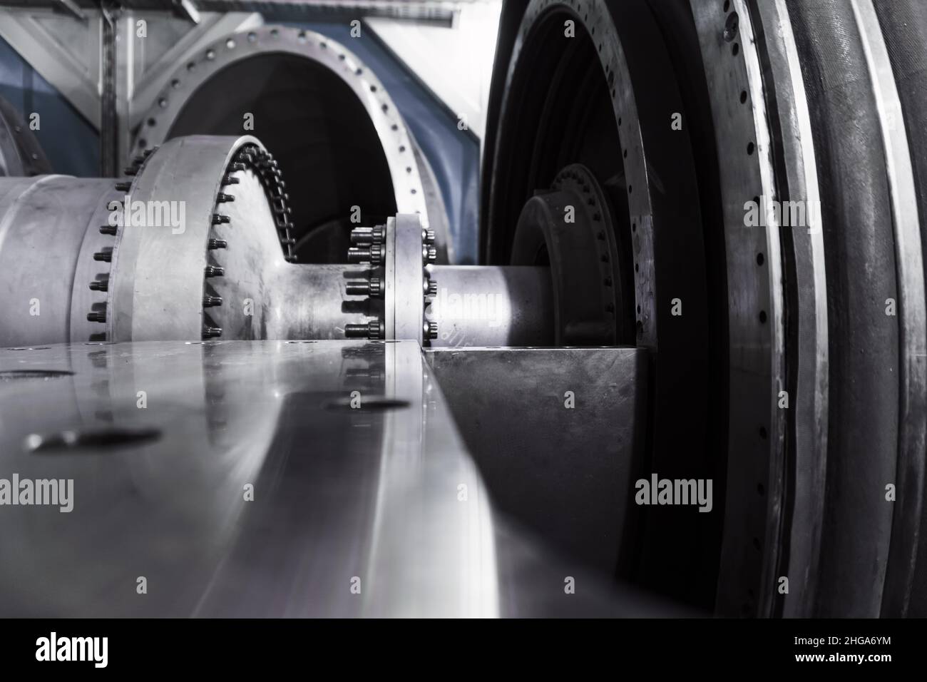 A gas turbine with a compressor rotor and a bolted coupling half ...