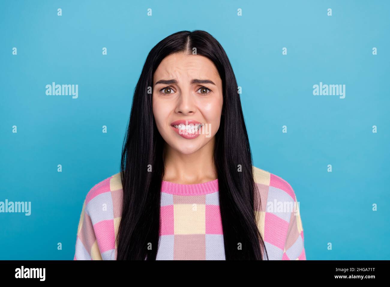Photo of guilty scared young woman wear pink sweater biting lip ...
