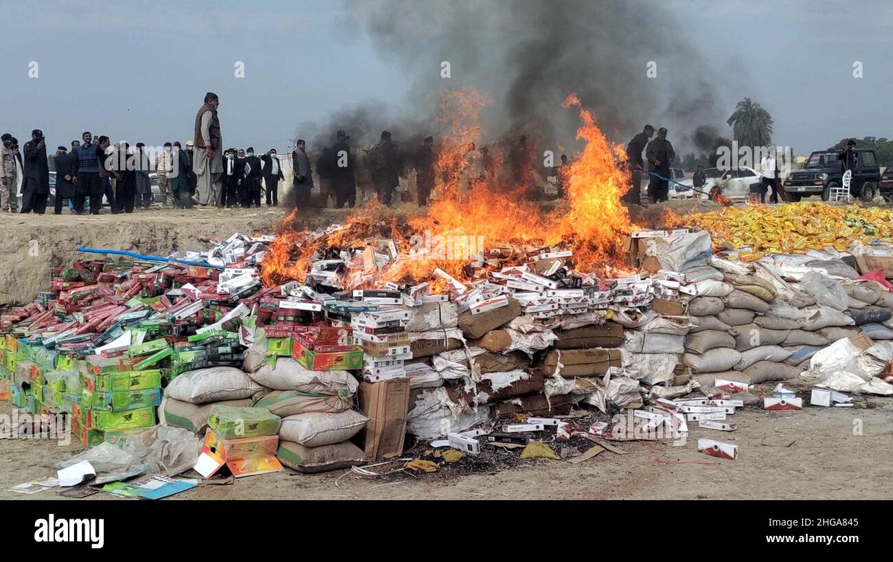 View of destroying liquor bottles and burning pile of confiscated drugs ...