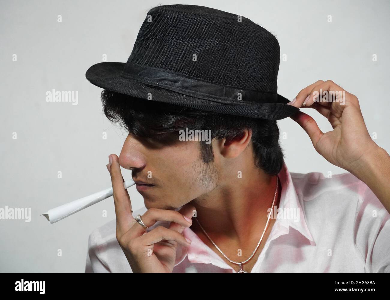 Close up young man smoking a cigarette Stock Photo - Alamy