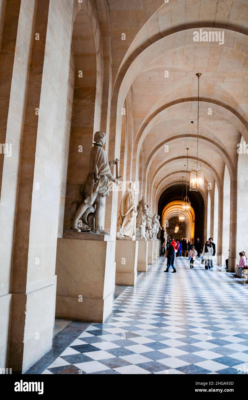 Arched vaulted ceiling and checkered marble floor of a statue lined ...