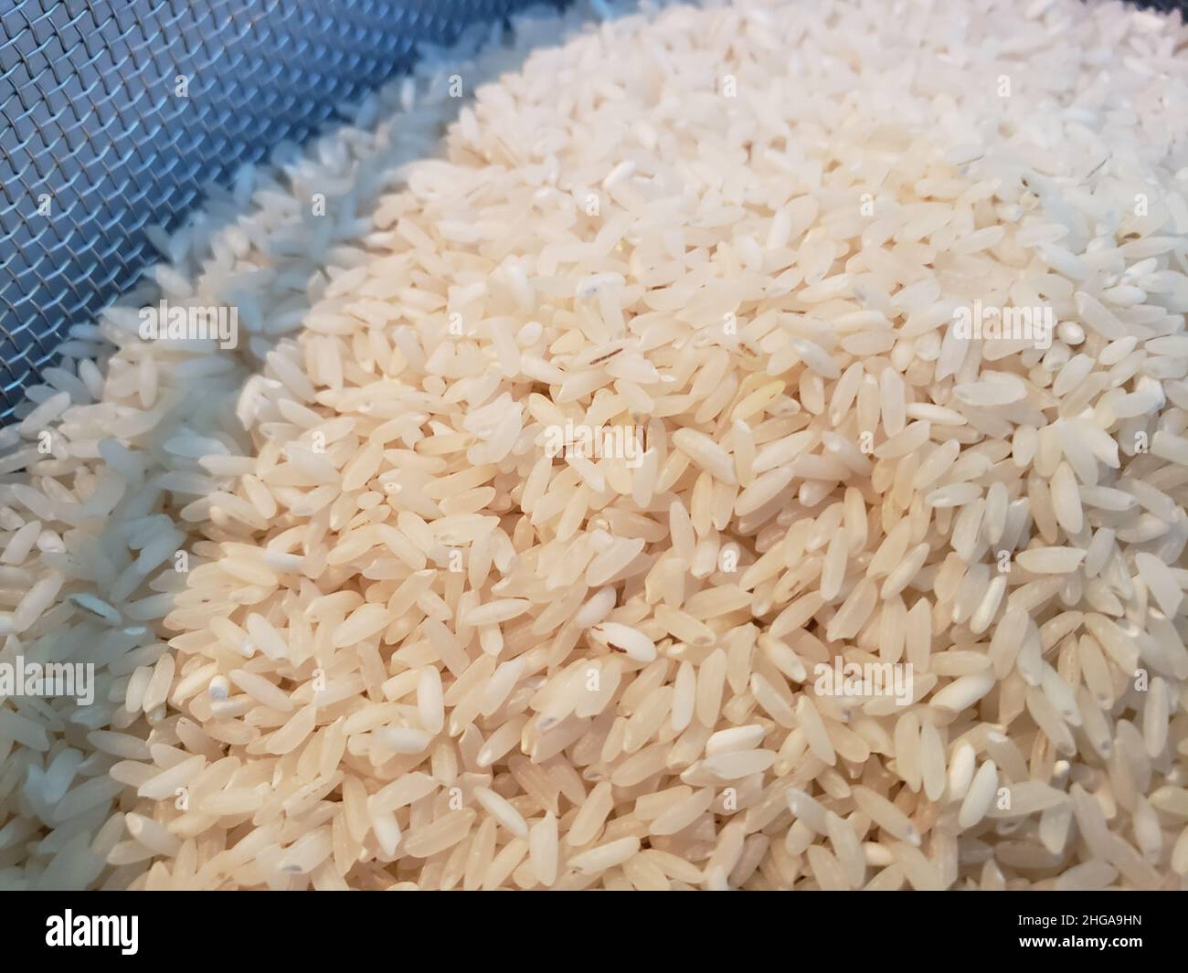 Several cups of rice sitting in a strainer Stock Photo - Alamy