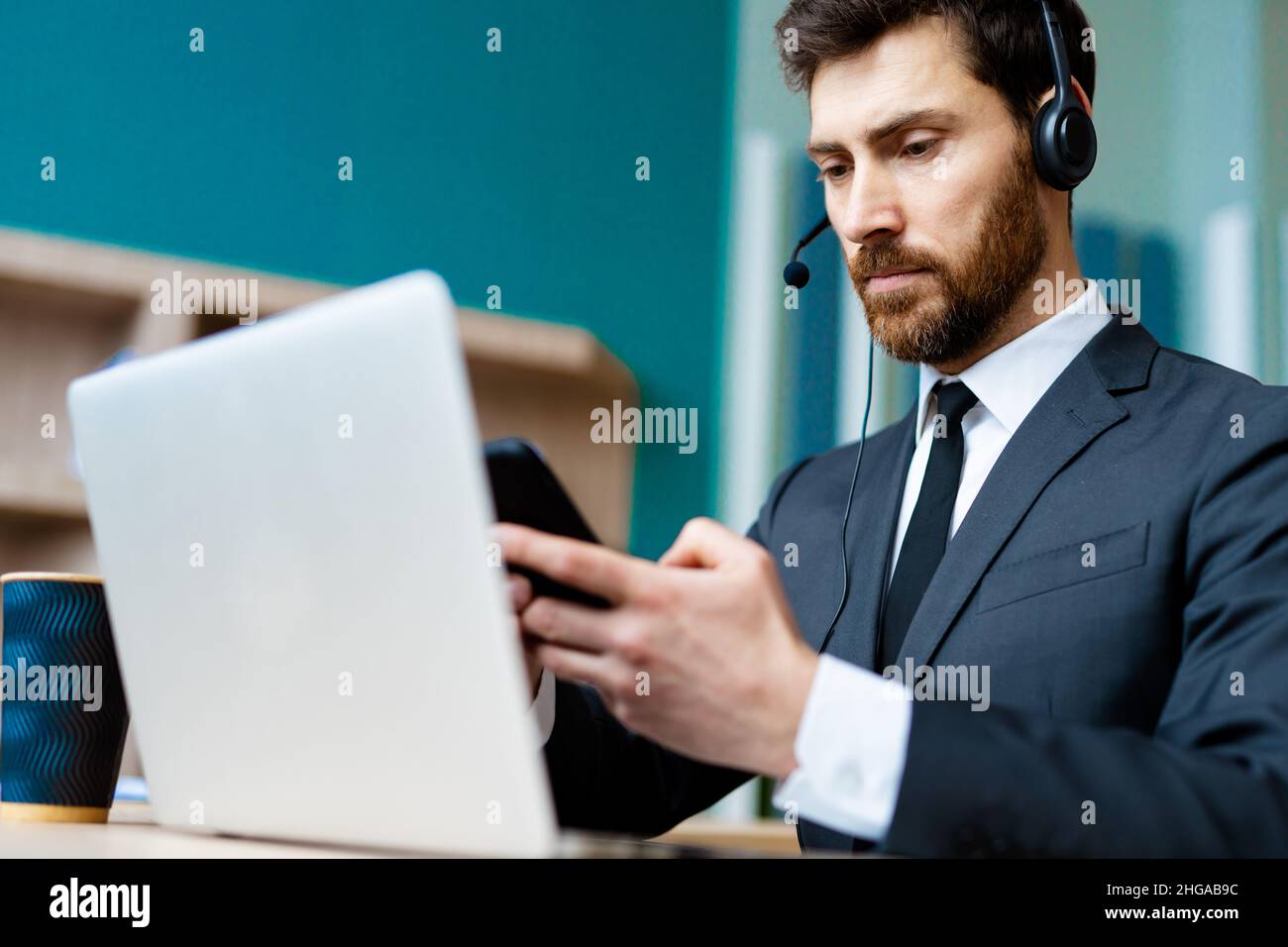 Businessman with elegant suit sitting at computer desk in the office ...