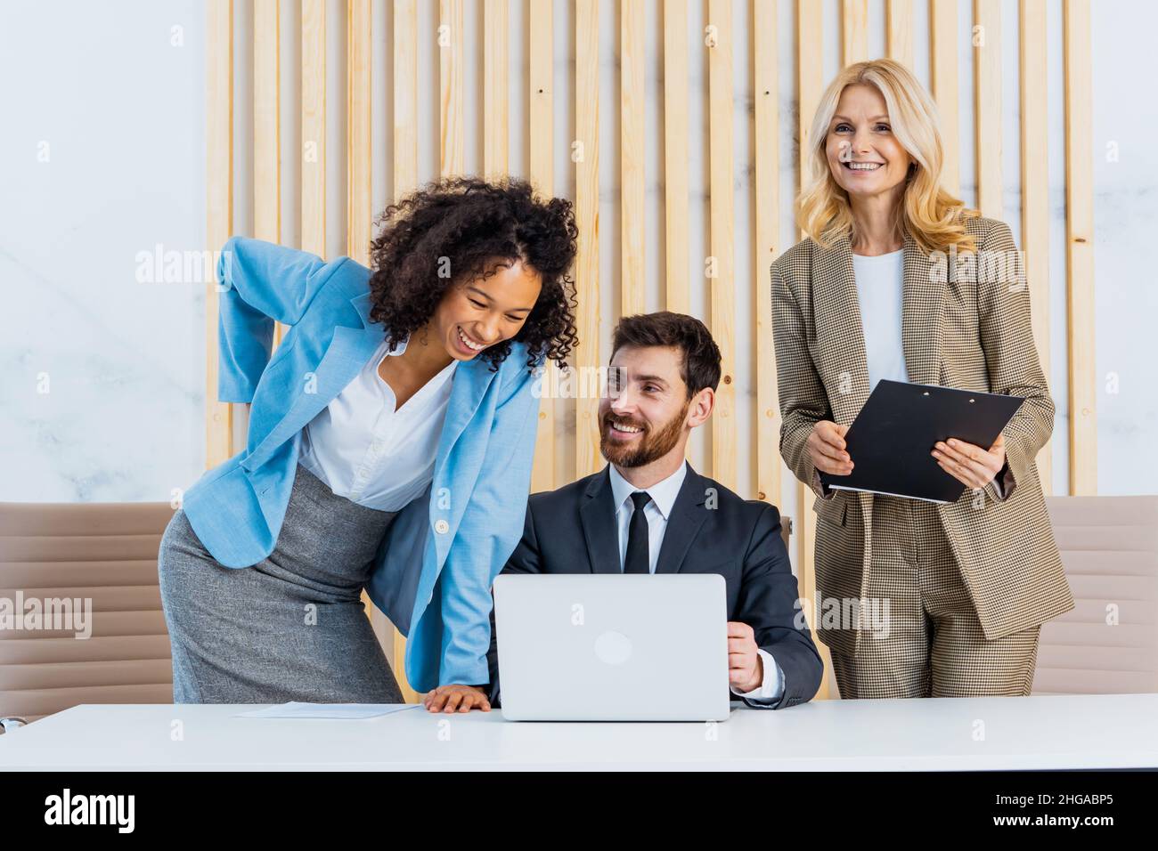 Multiracial group of businesspeople with elegant dress sitting at ...