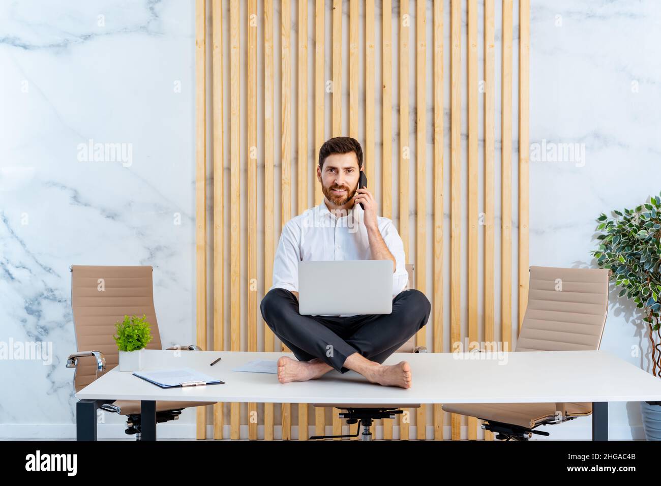 Businessman with elegant suit sitting at computer desk in the office in ...