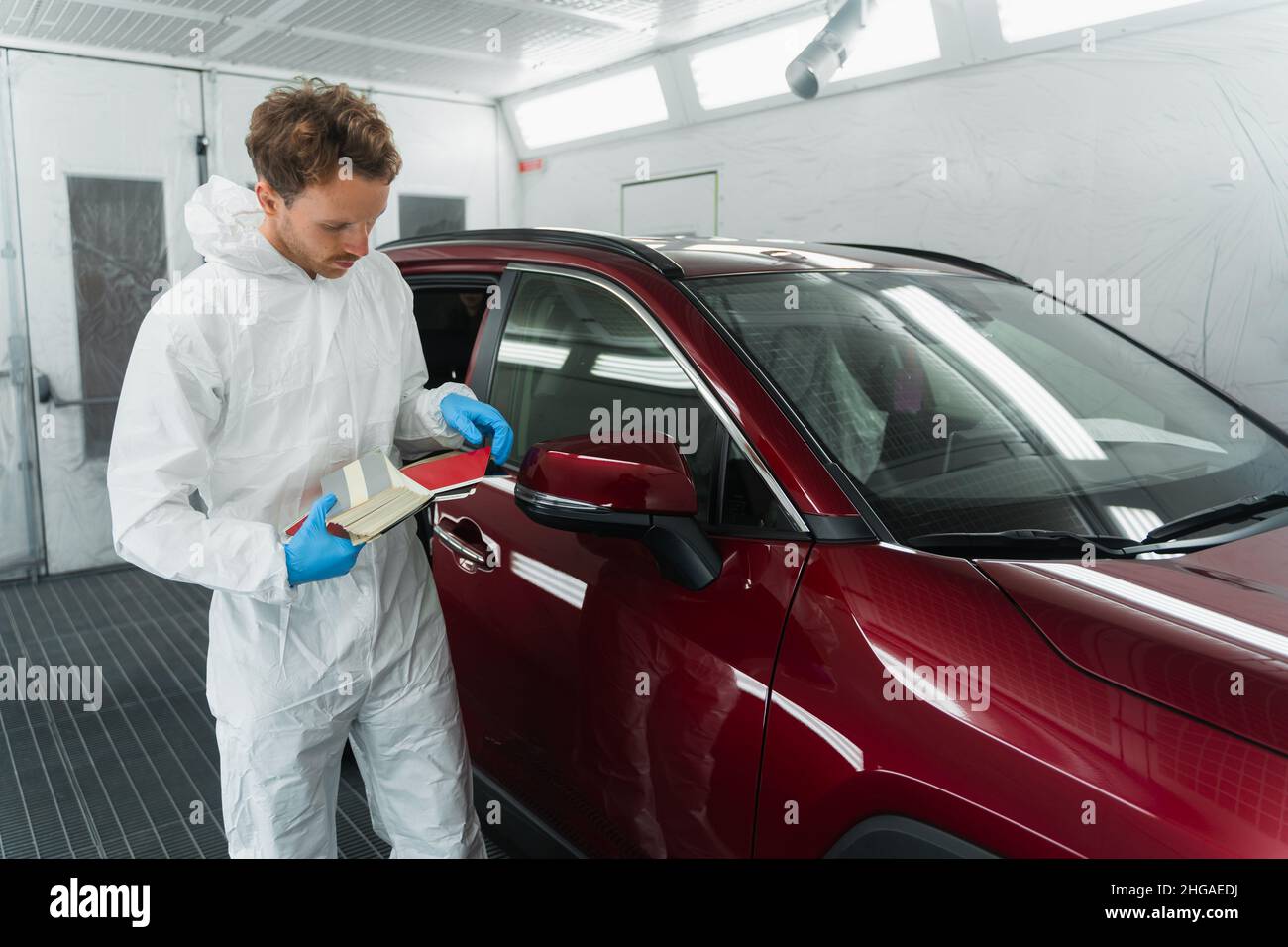 Auto colorist selects car paint color with samples Stock Photo - Alamy