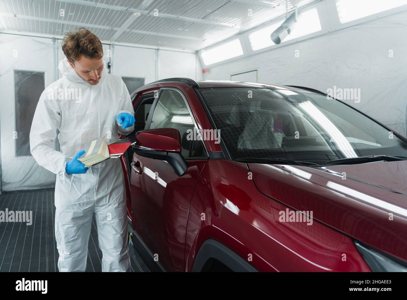 Auto colorist selects car paint color with samples Stock Photo - Alamy