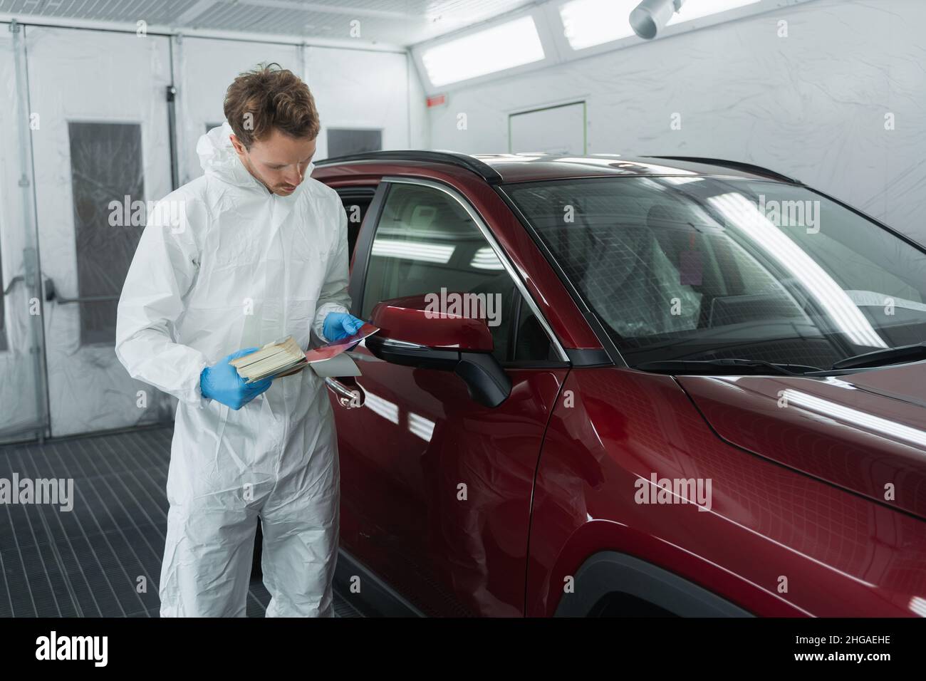 Auto colorist selects car paint color with samples Stock Photo - Alamy