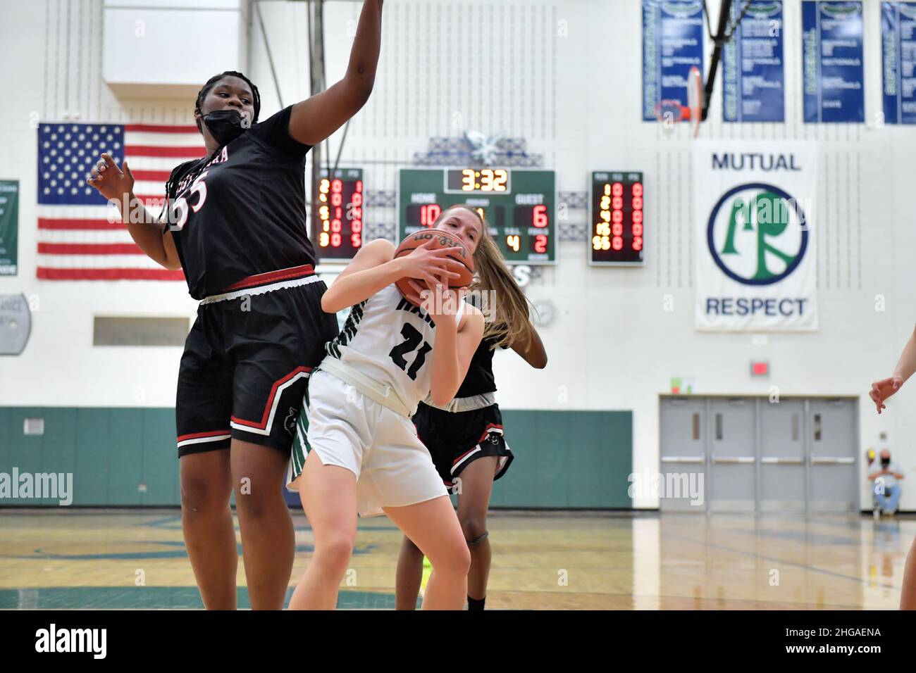 USA. Player cradles the basketball after securing a rebound under the ...