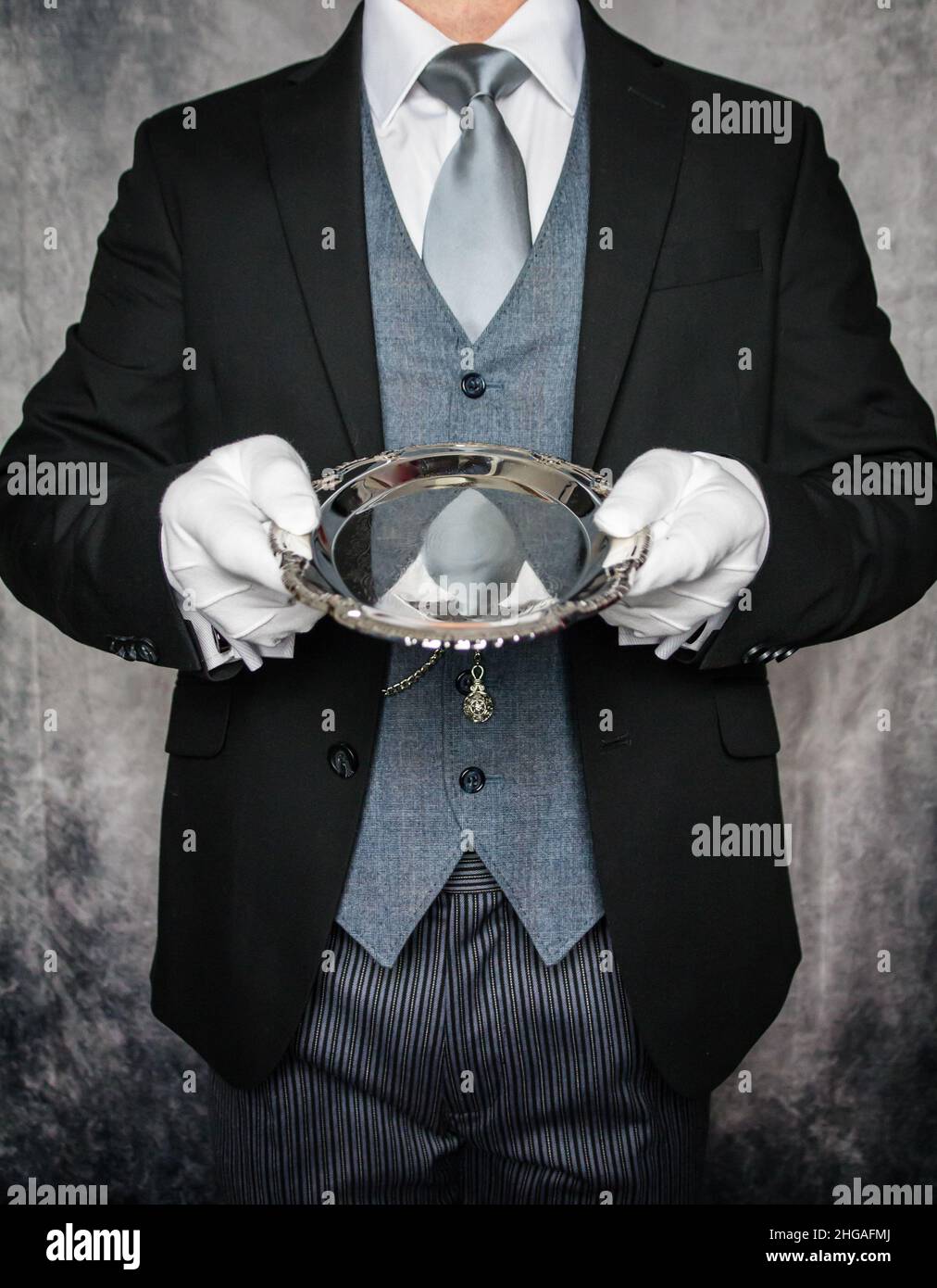 Portrait of Formal Elegant Butler in Dark Suit and White Gloves Holding ...