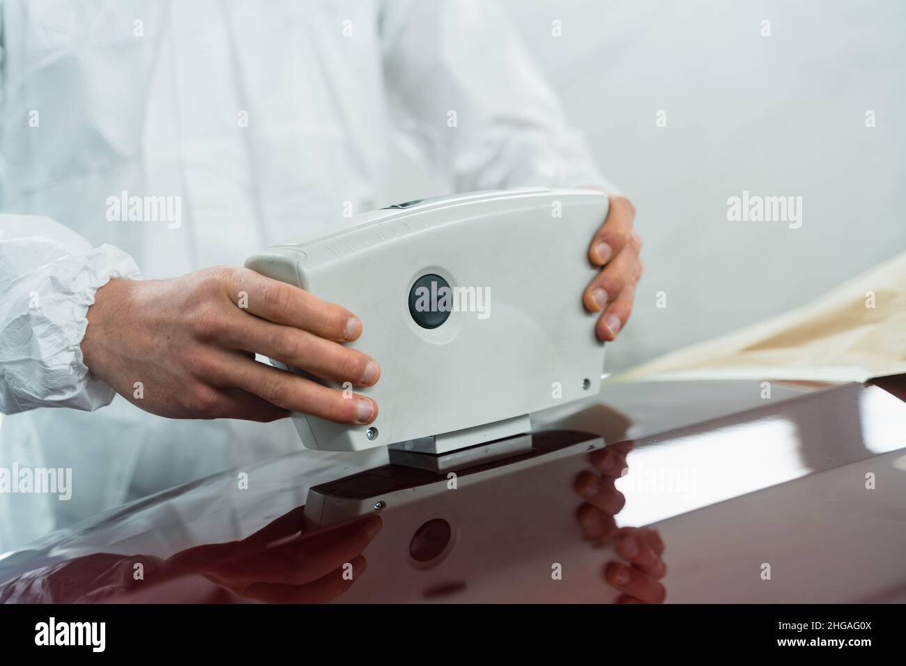 Close-up view of a auto painter determining the exact shade of a car's ...