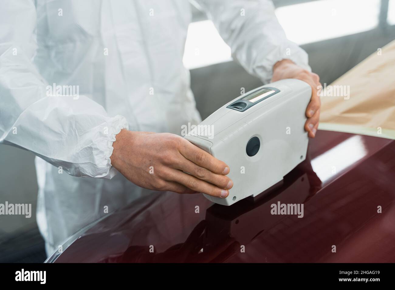 Close-up view of a auto painter determining the exact shade of a car's ...