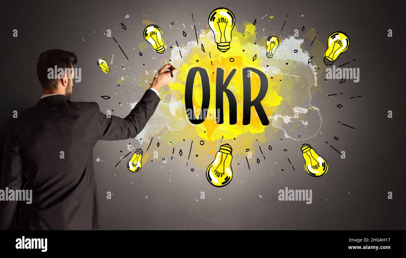 man drawing colorful light bulb Stock Photo - Alamy