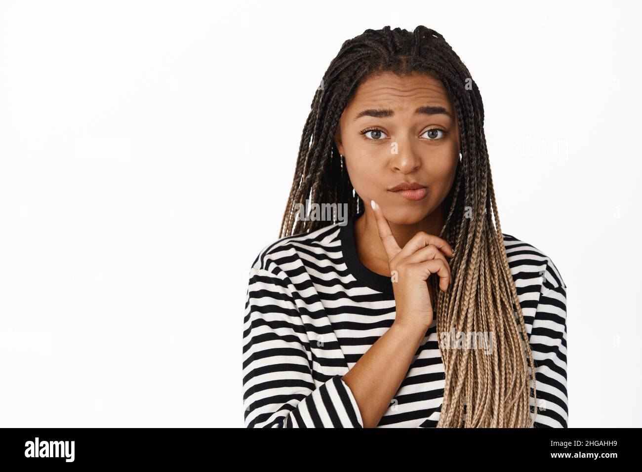 Thoughtful college girl looking unsure, thinking, making decision or ...