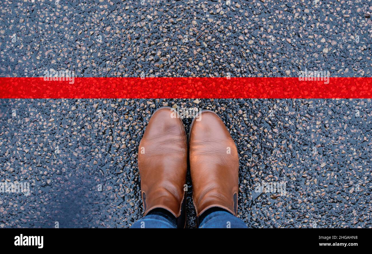 Red line on the road, someone is standing in front of the stop, covid ...