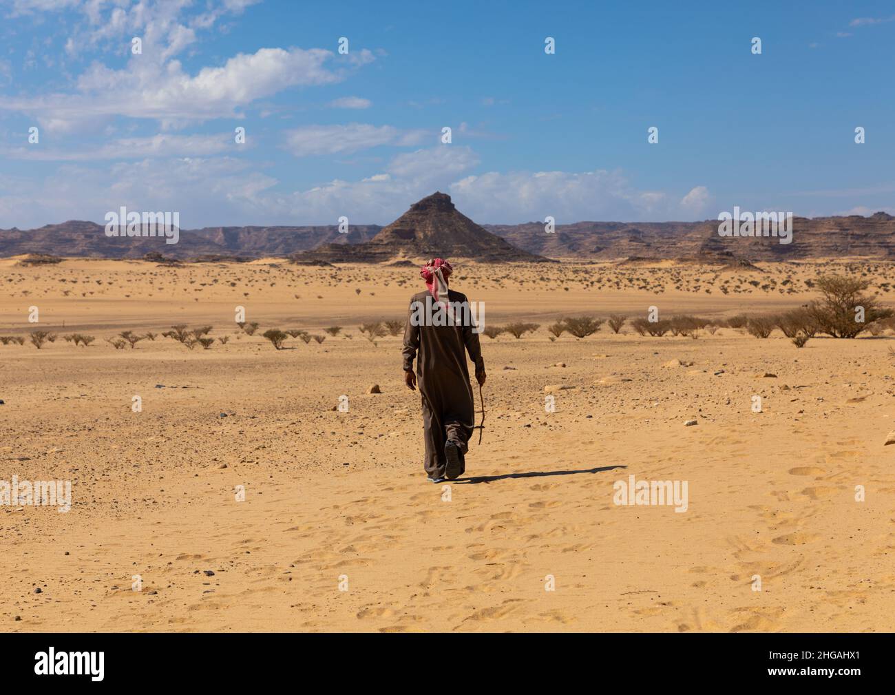 Saudi man walking in the desert, Najran Province, Thar, Saudi Arabia ...