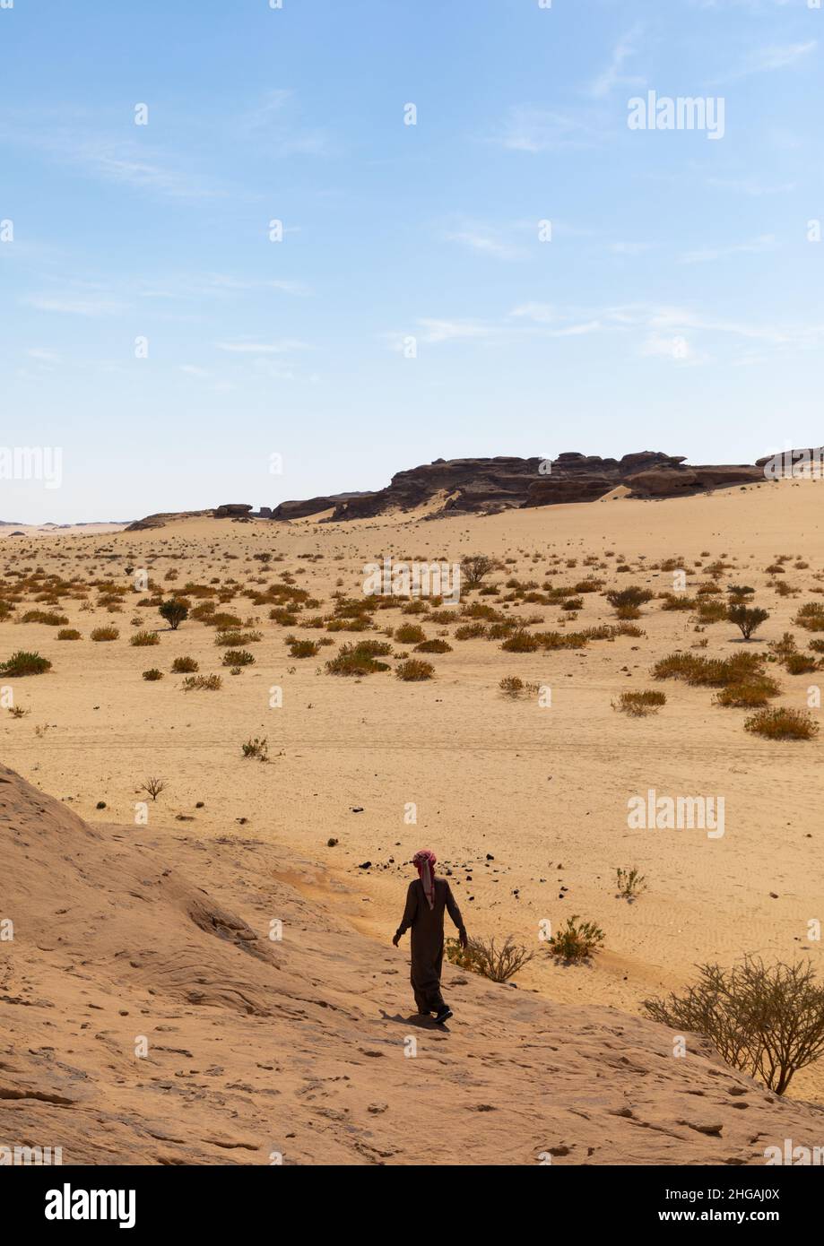 Saudi man walking in the desert, Najran Province, Thar, Saudi Arabia ...