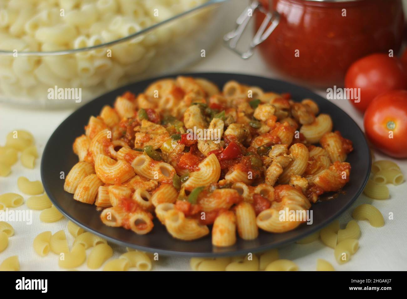 Red sauce macaroni pasta, shot with red tomatoes and red sauce in a jar ...