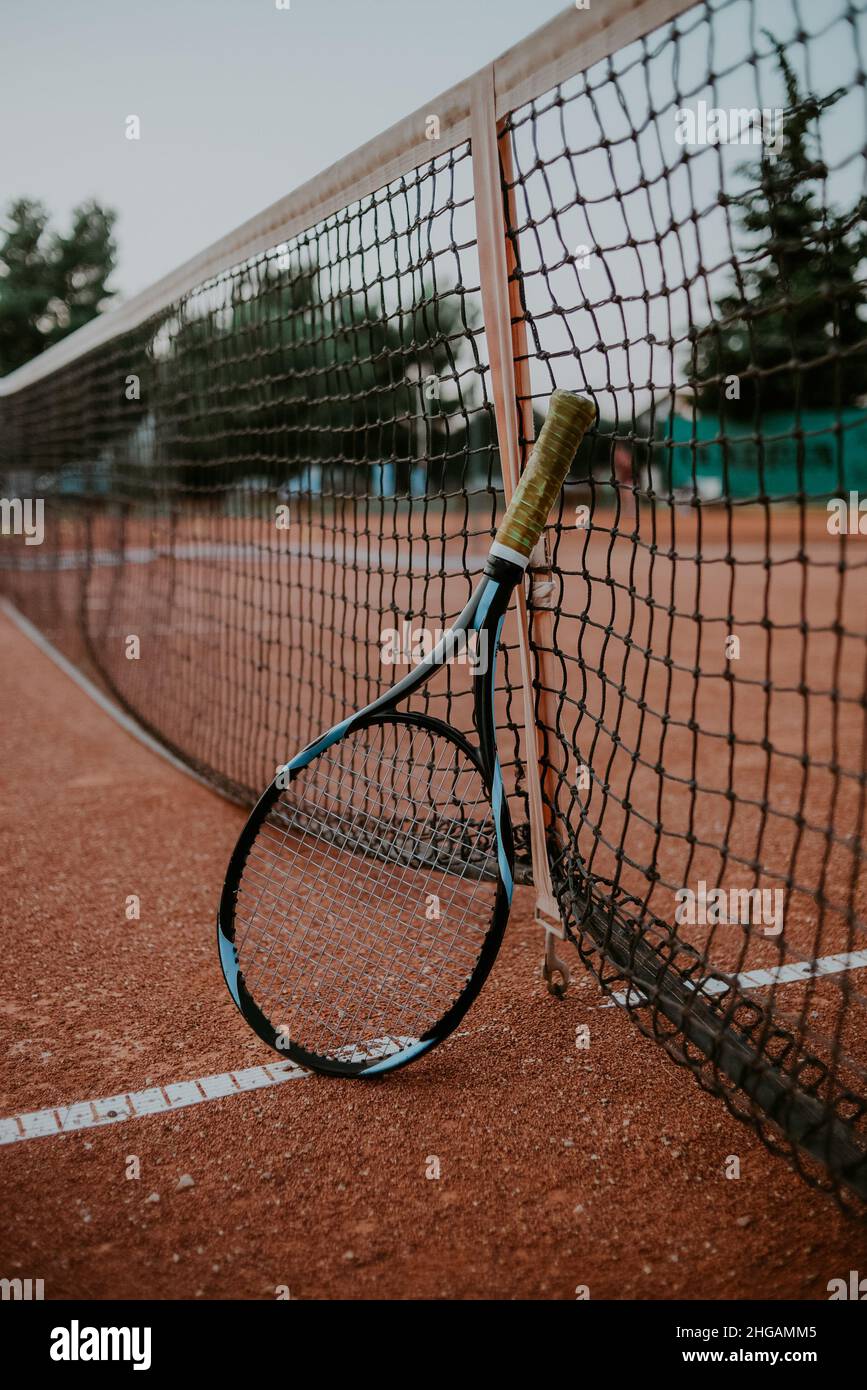 Tennis racket and tennis net. Large outdoor tennis field, sports ...