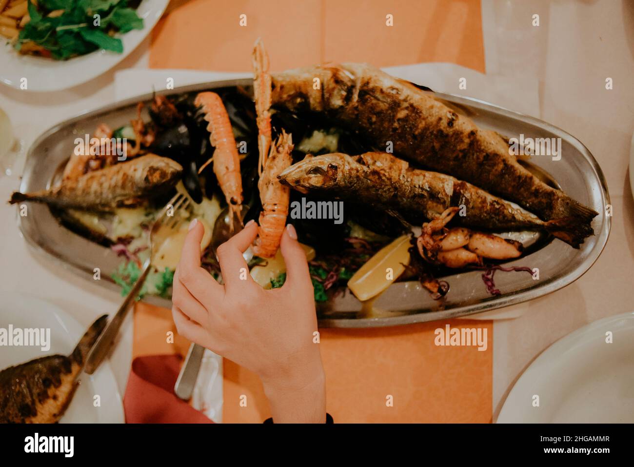 Large plate of seafood, king prawns and fish. Dinner by the sea. The ...