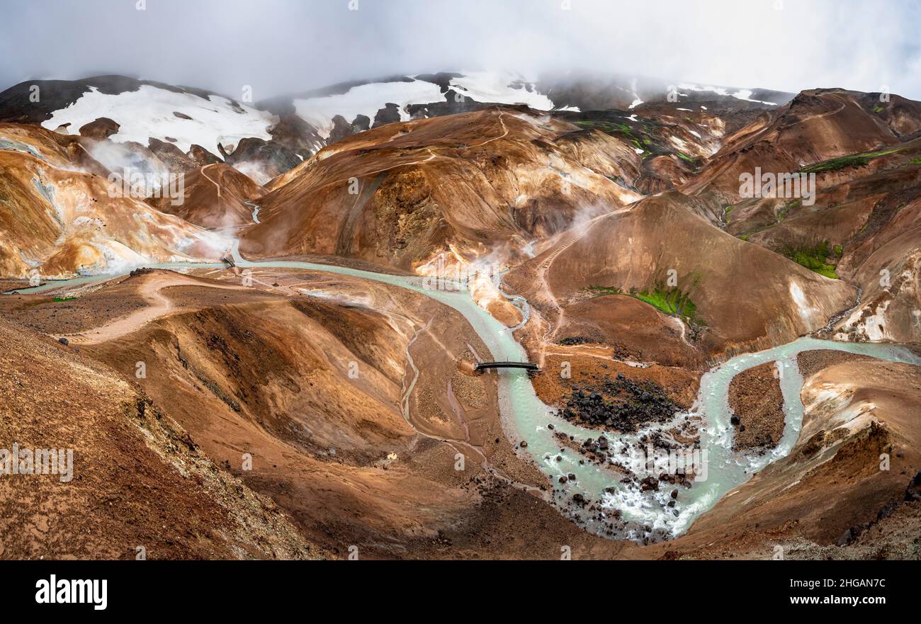 Red coloured rocks, river flowing through Kerlingarfjoll geothermal ...