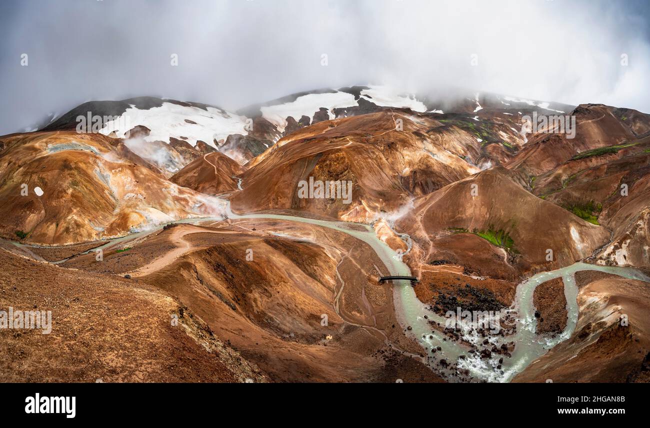 Red coloured rocks, river flowing through Kerlingarfjoll geothermal ...