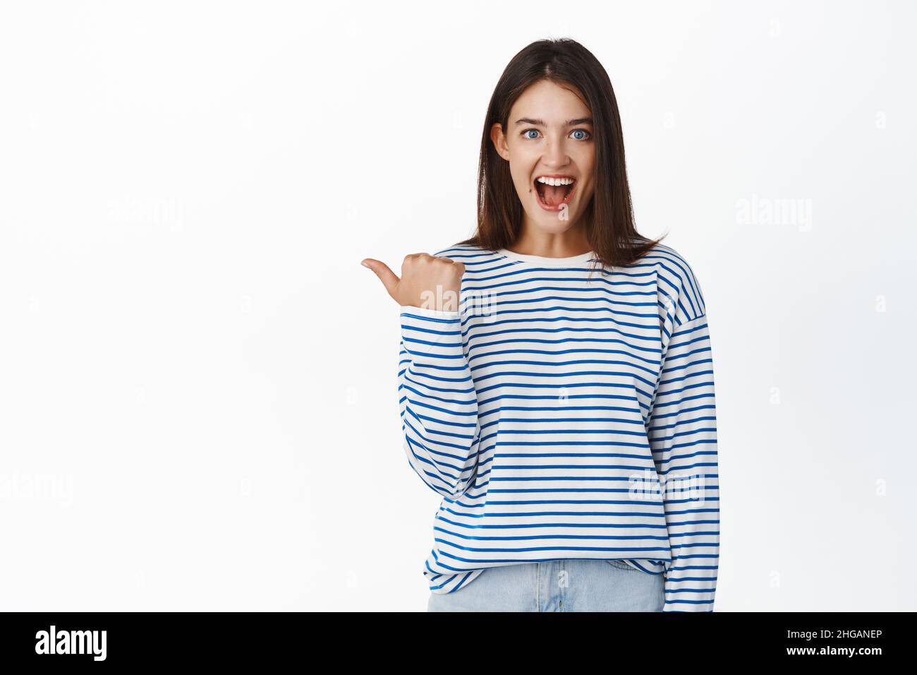 Check this out. Smiling happy young woman presenting something ...