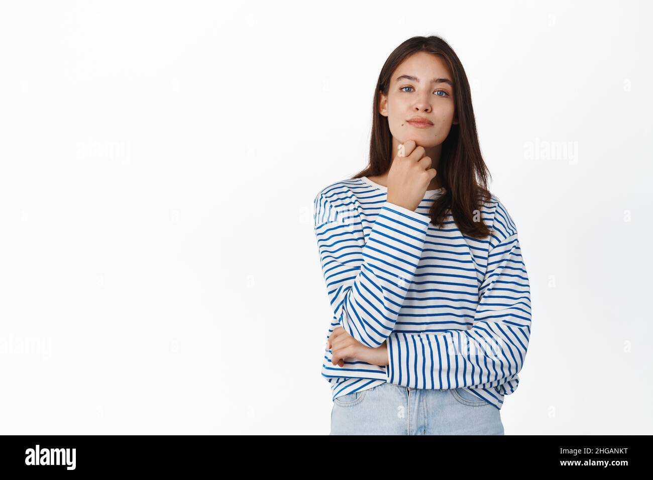Image of thoughtful brunette girl looking at camera, thinking, making ...
