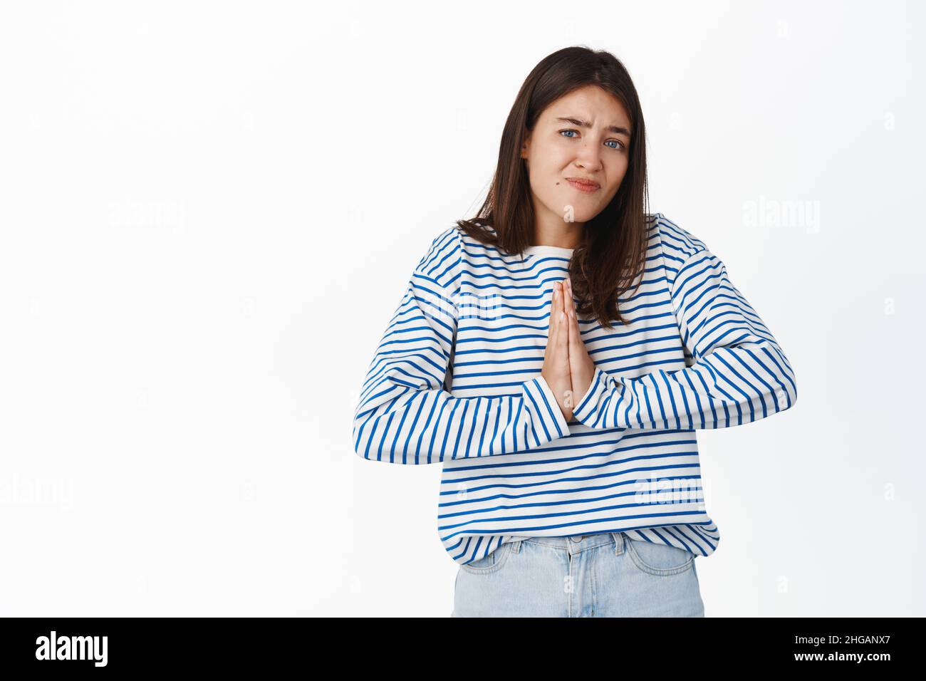 Please. Cute brunette woman asking for help, begging you, looking in ...