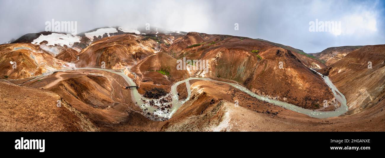 Red coloured rocks, river flowing through Kerlingarfjoll geothermal ...