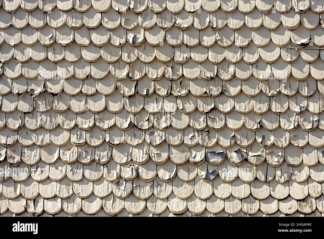 pattern of old wooden shingles with peeling paint, facade, background ...